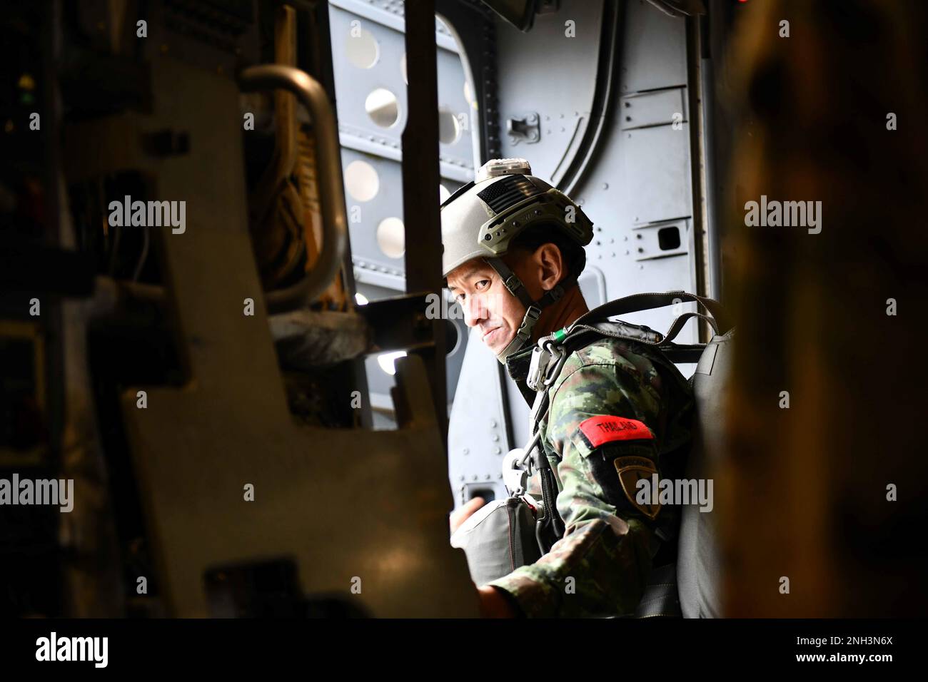 A jumpmaster from the Royal Thai Army waits at the door of a C-17 ...