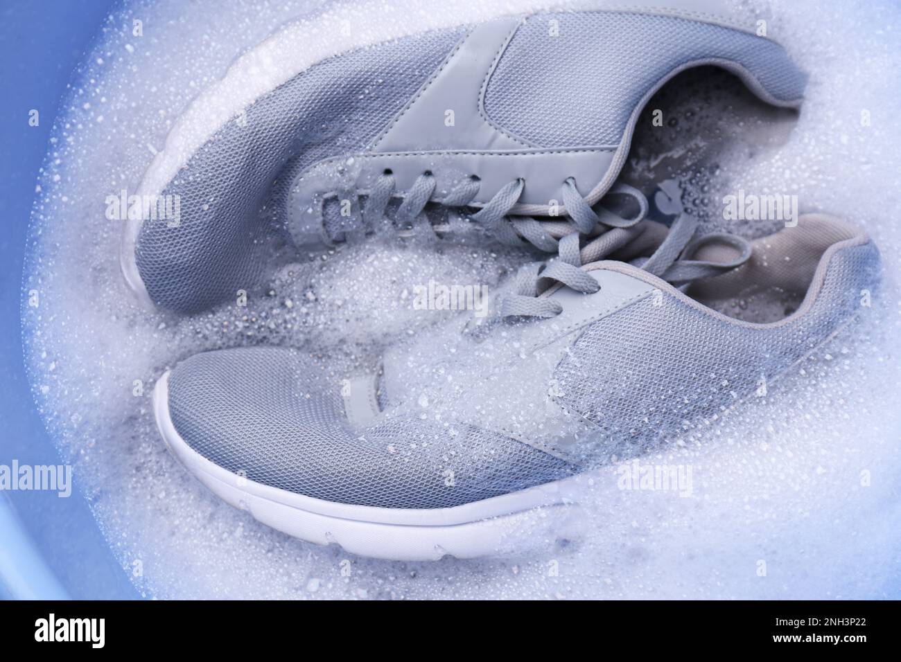Washing sport shoes in plastic basin, top view Stock Photo - Alamy