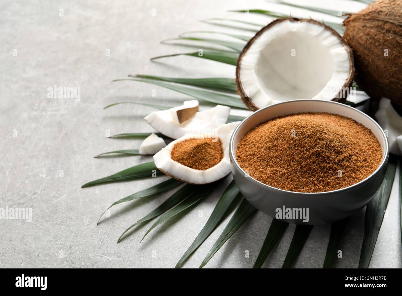 Composition with natural coconut sugar on grey table, space for text ...