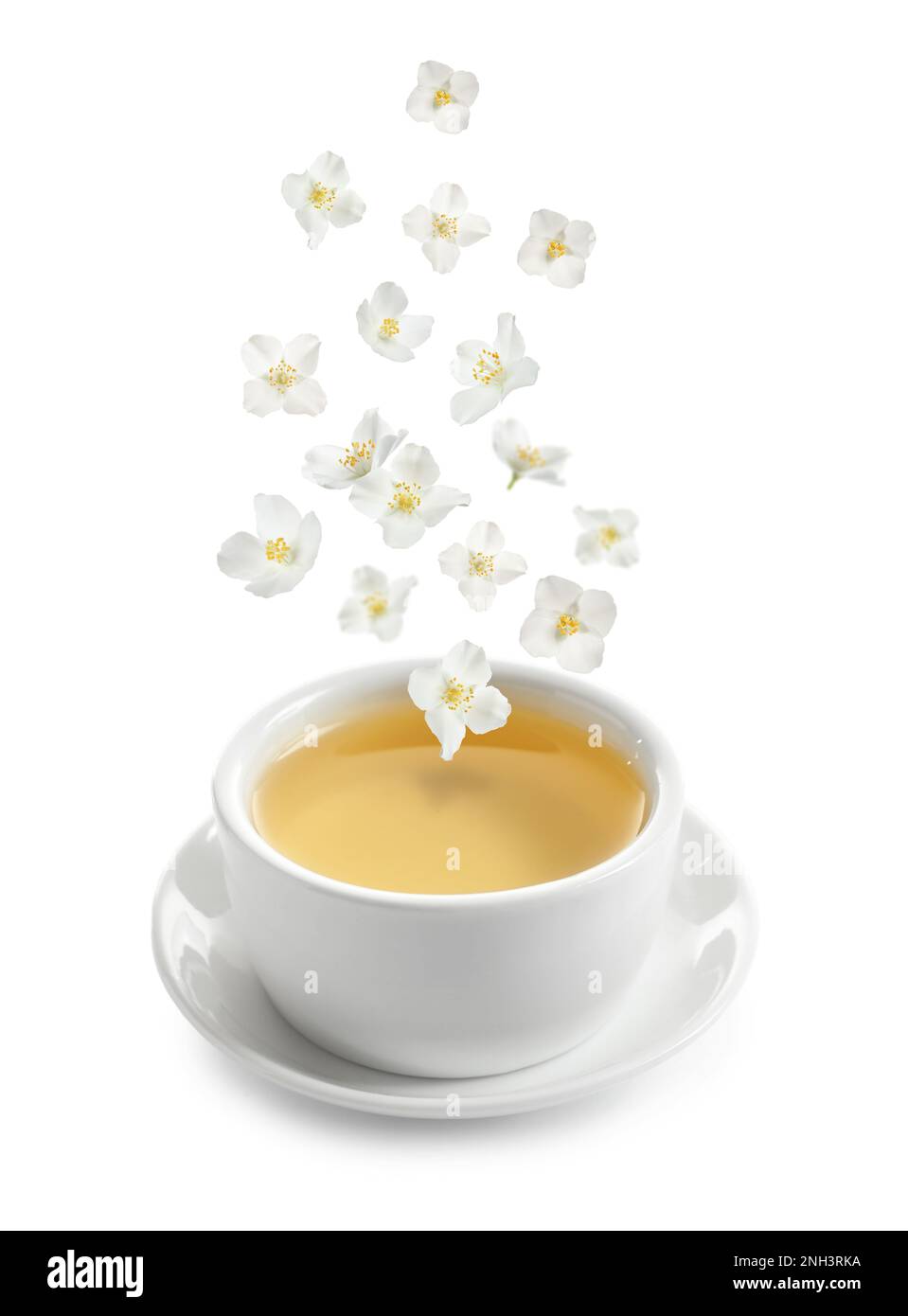 Beautiful jasmine flowers falling into cup of hot freshly brewed tea on ...