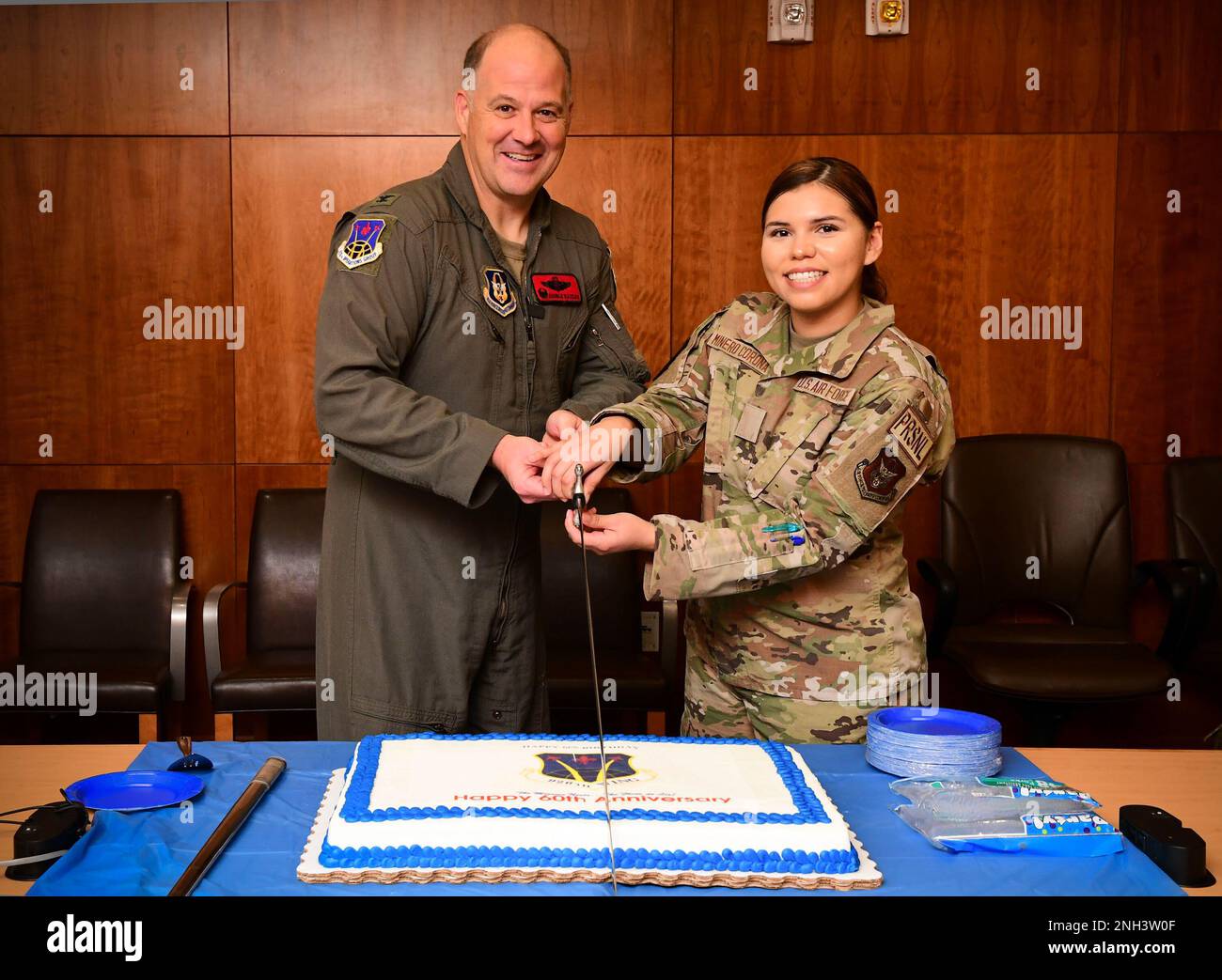Col. Sean Rassas, 926th Wing commander, cuts a cake with Airman Yulissa ...