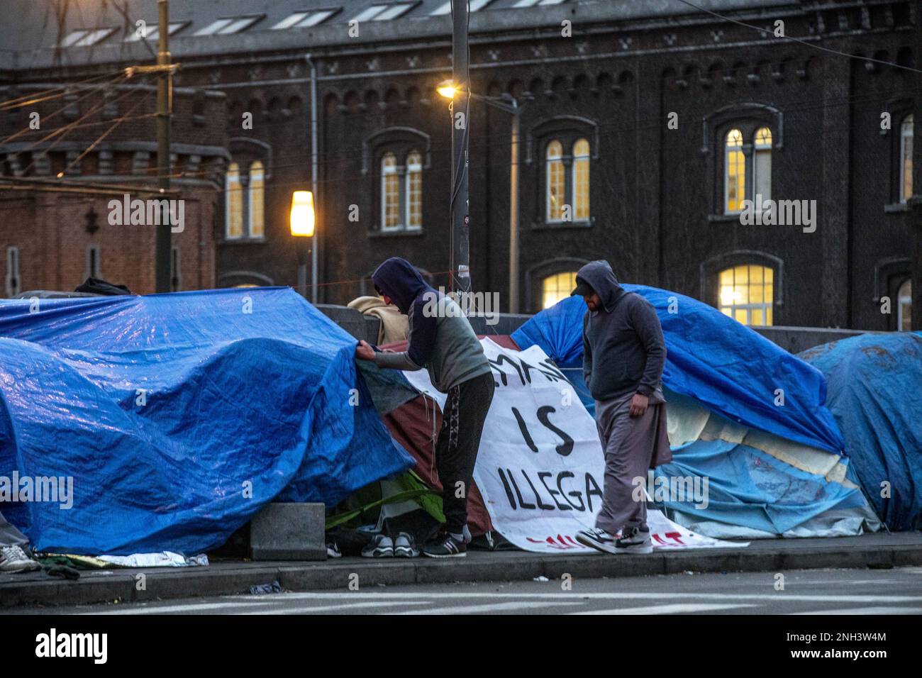 Illustration shows refugees in the tents in front of the Petit Chateau ...