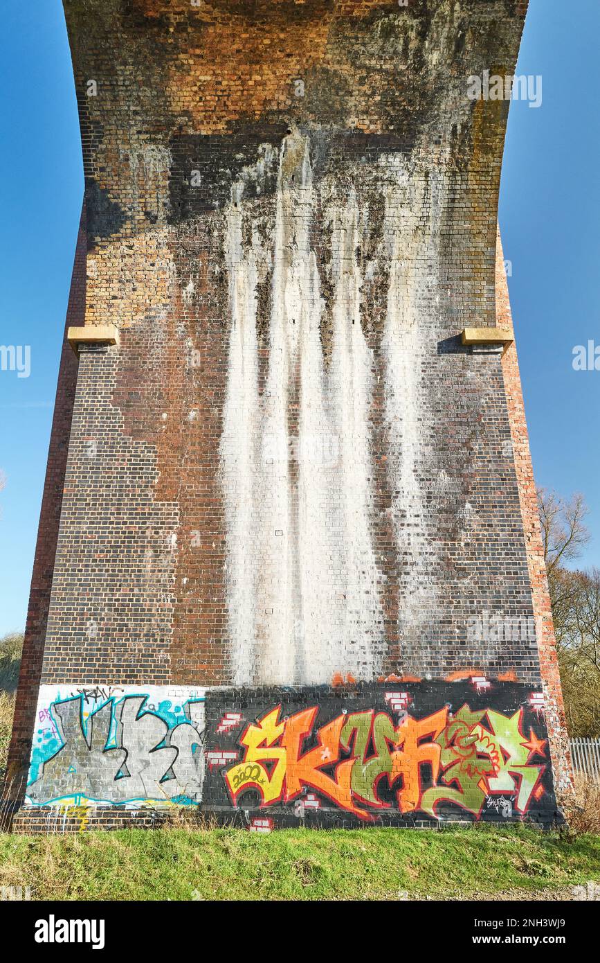 Graffiti on an arch of the victorian brick built railway viaduct at ...