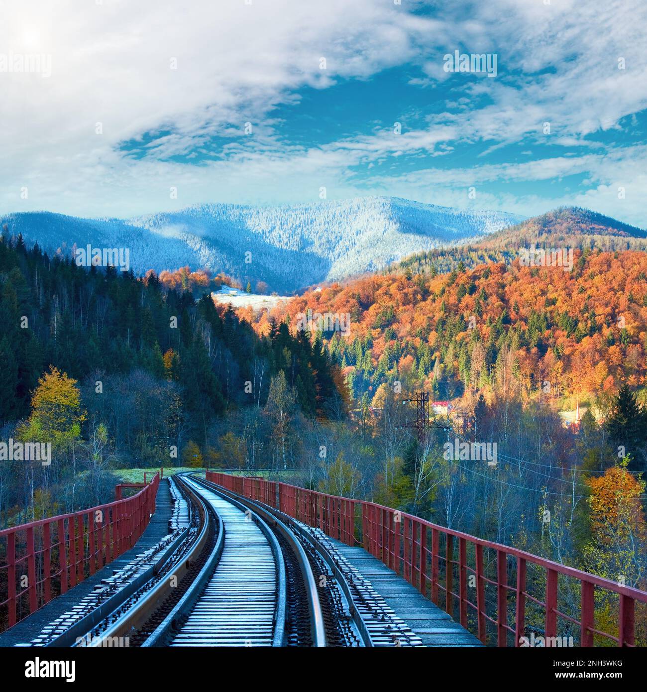Railway on bridge and first autumn snow on far mountains Stock Photo ...