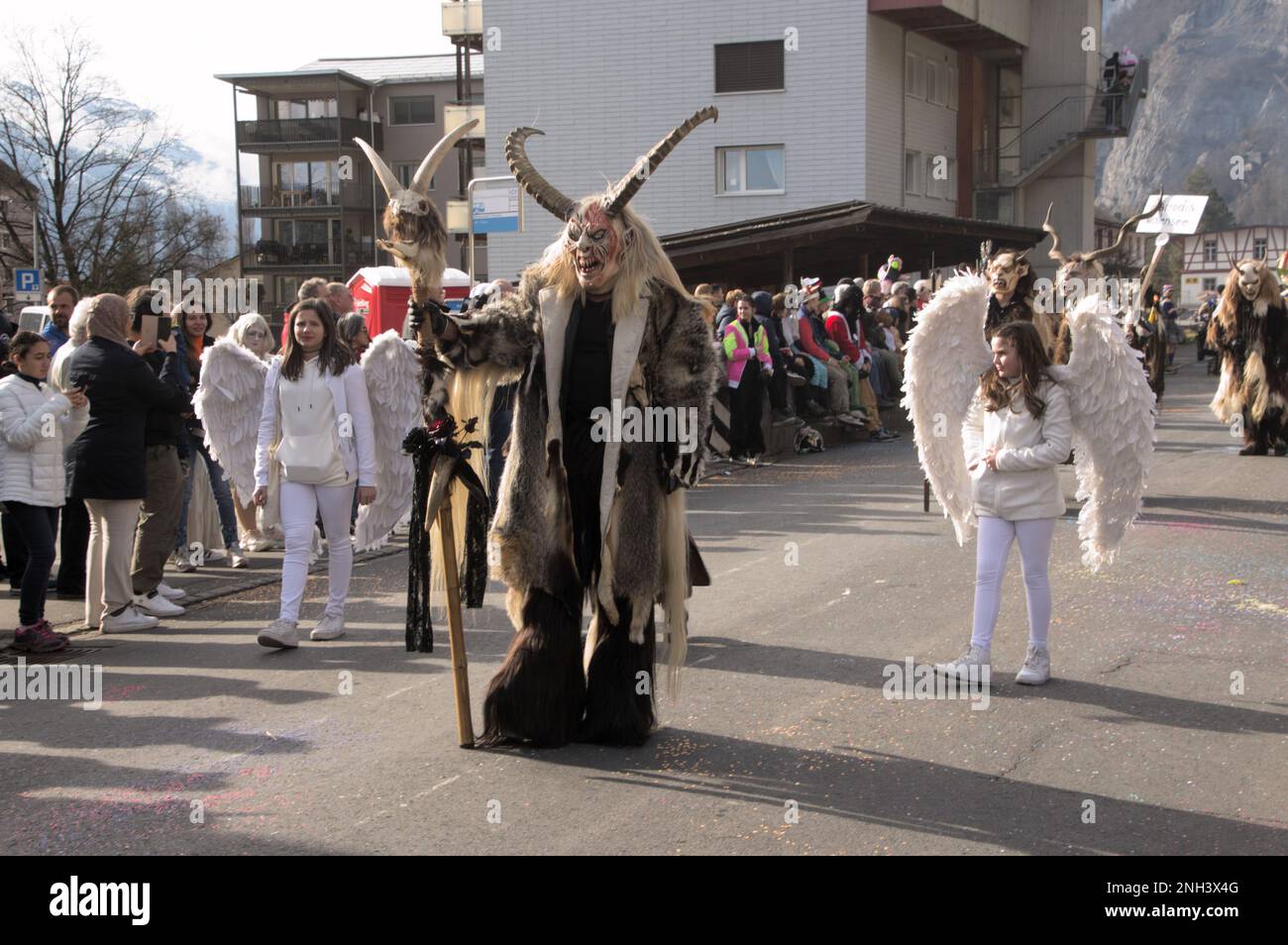 Demon and angel costumes at the Walenstadt Fasnacht procession in the ...