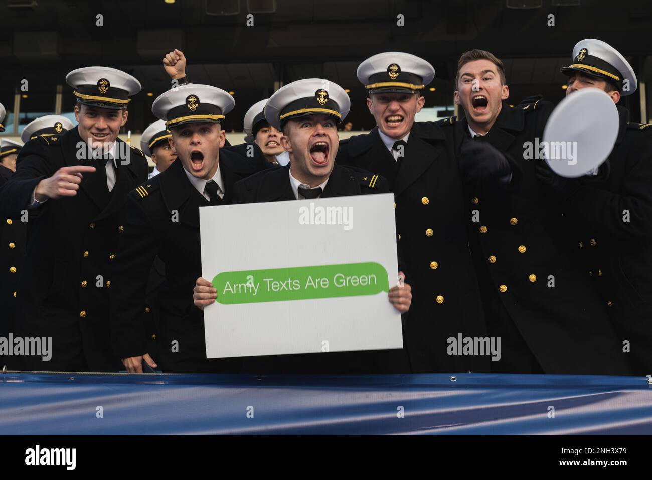 Midshipmen cheer during the annual Army-Navy football game ...