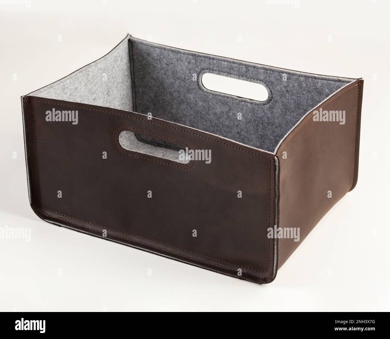 Brown faux leather storage box with felt lining and handles Stock Photo ...