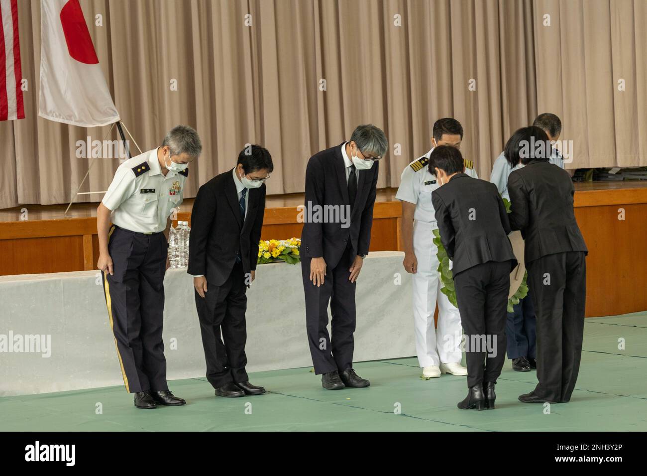 Government of Japan representatives bow during the 2022 Reunion of ...
