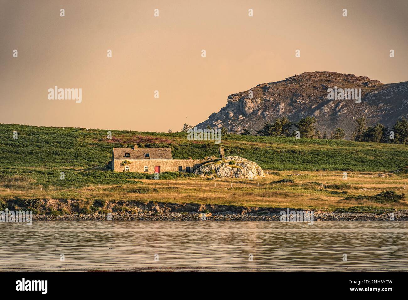 Side view of Beginish Island from Valencia Harbour in calm, peaceful ...