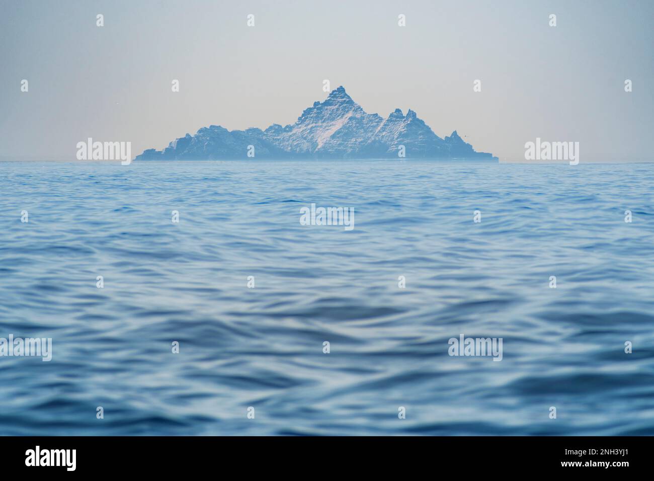 Great Skellig Island at the horizon in calm, peaceful weather. Atlantic ...