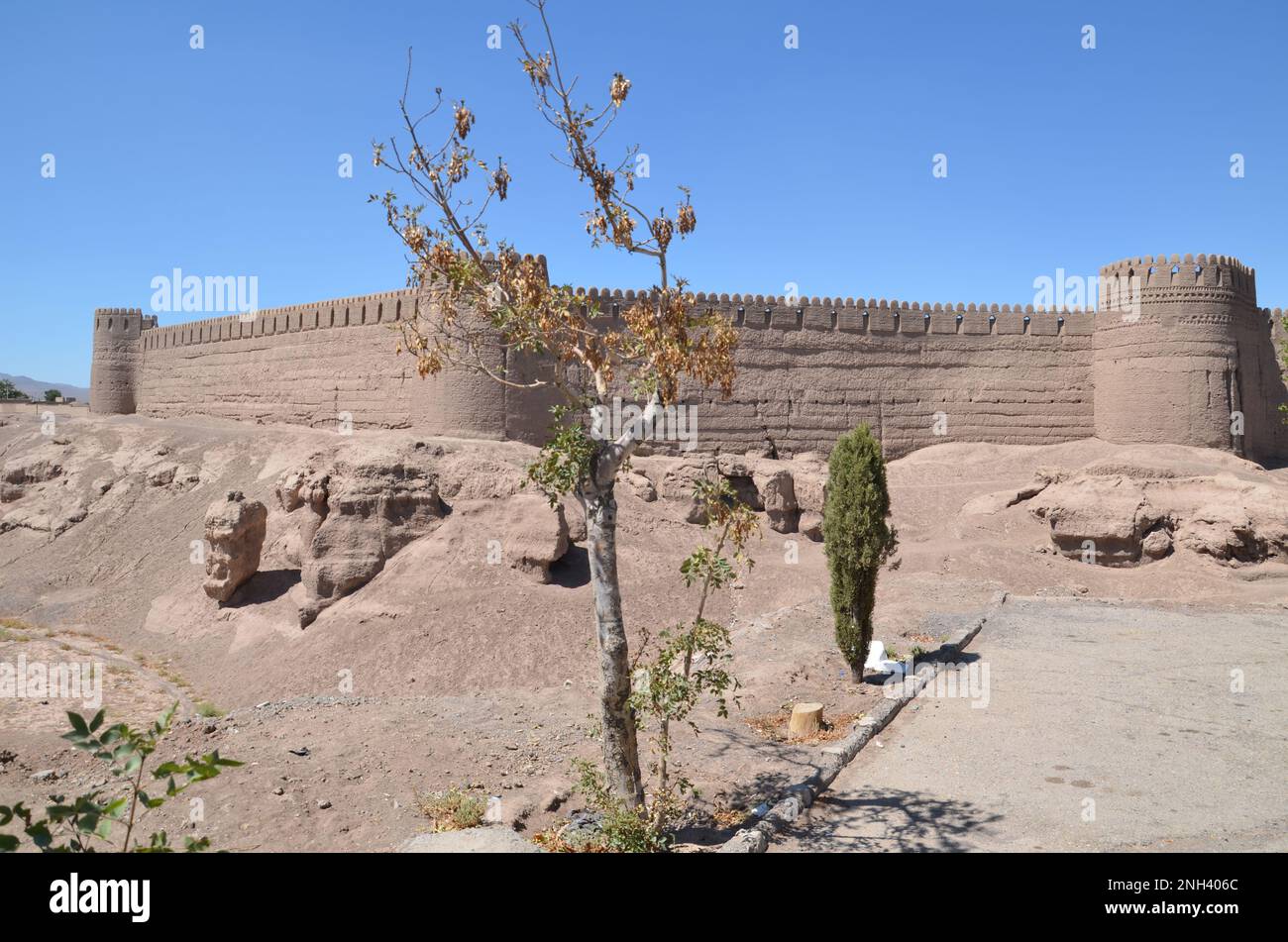 dry desert landscape with mountains and the walls of Rayen Citadel ...