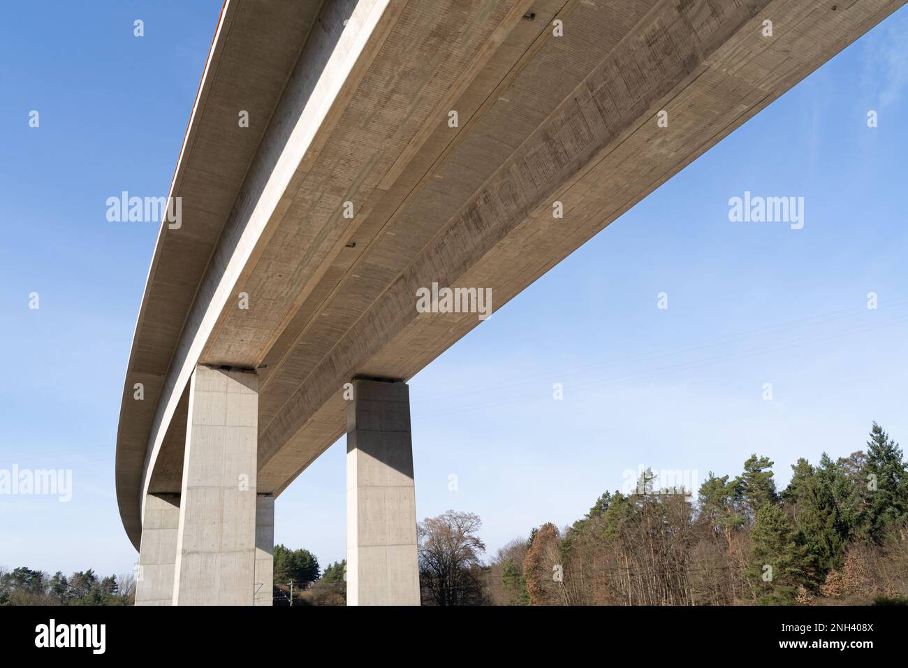 Large modern concrete highway bridge from below in the countryside with ...