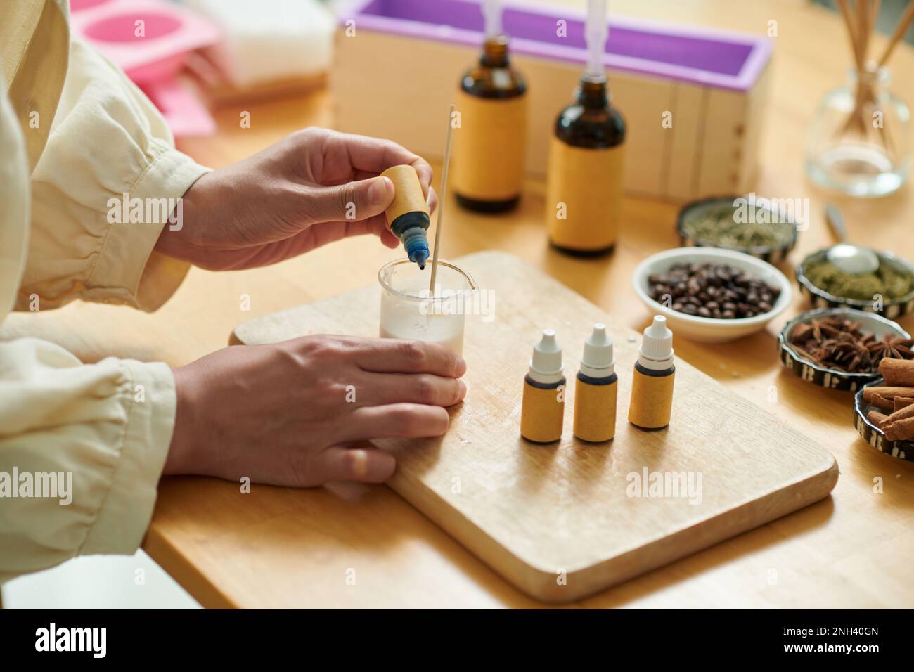 Hands of woman adding colorant into soap base Stock Photo - Alamy