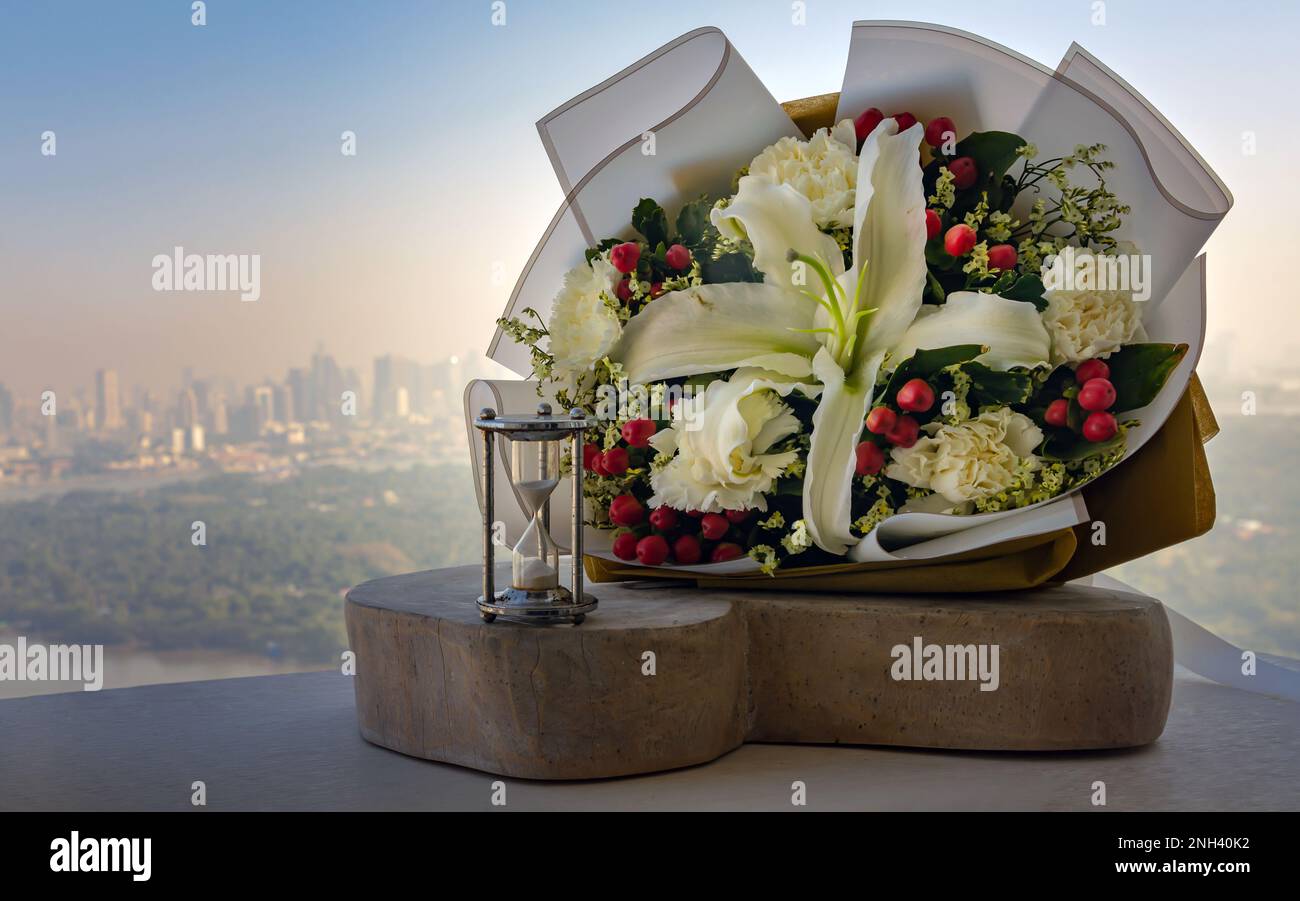 Hourglass or Sandglass is next to Bouquet of flowers placed on the ...