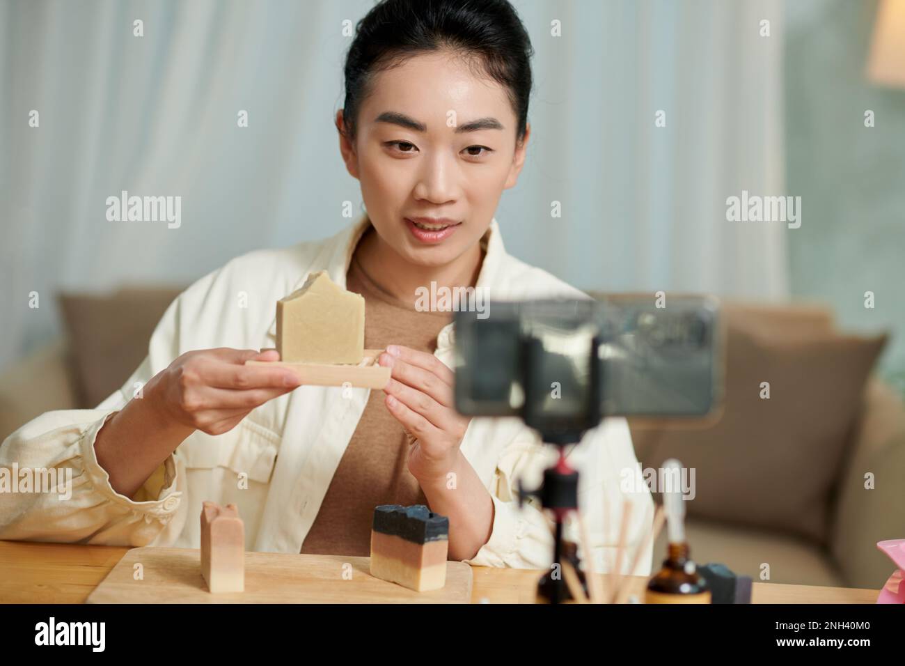 Young woman recording tutorial on making soap at home Stock Photo - Alamy