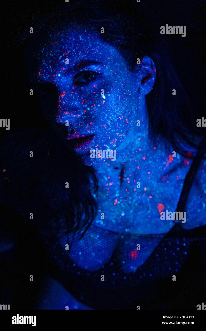 Portrait of a beautiful woman with blue sequins on her face. Girl with ...