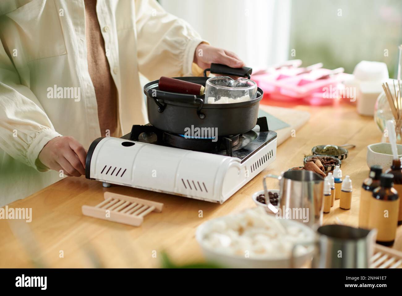 Closeup image of woman melting soap base in water bath Stock Photo - Alamy