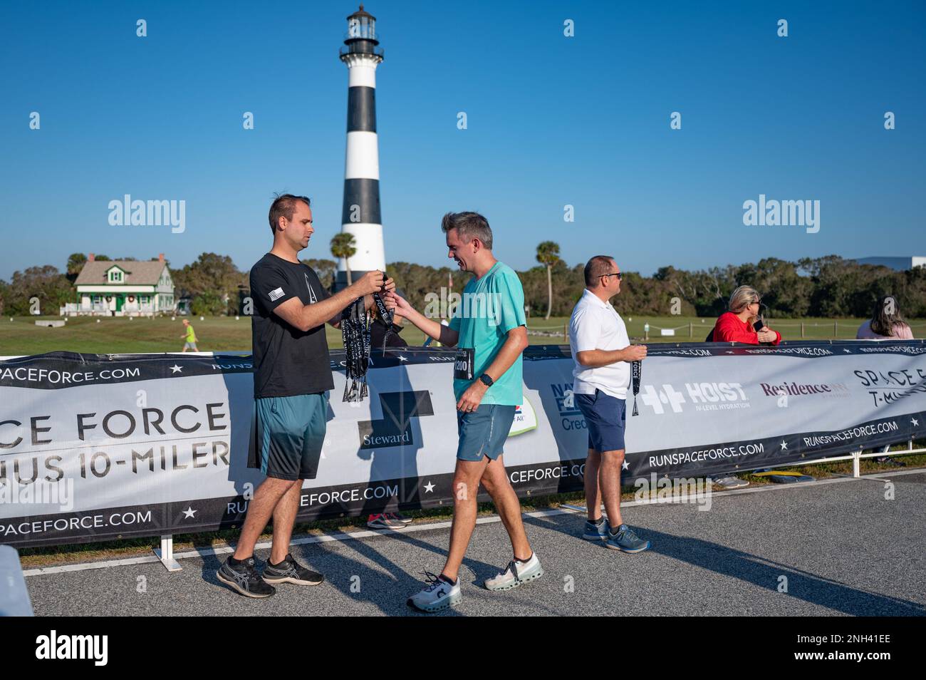 A participant in the Space Force T-Minus 10-Miler receives a medal ...