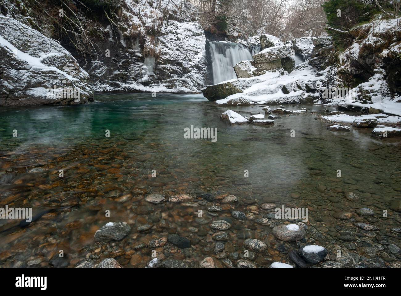 waterfall in winter with green water Stock Photo - Alamy