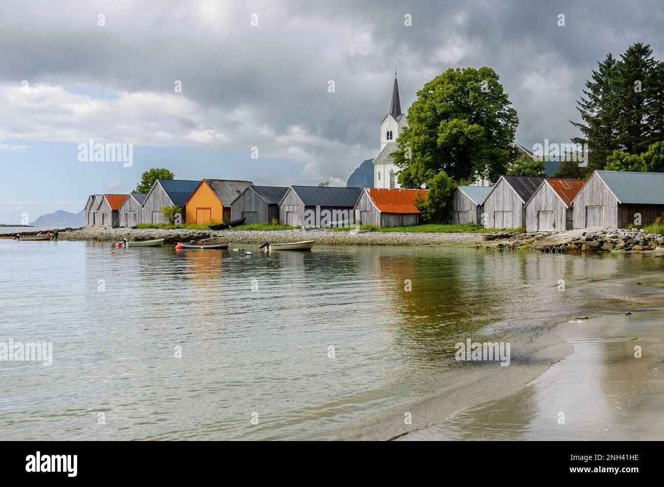 Quaint coastal village with traditional boathouses by the waters edge ...