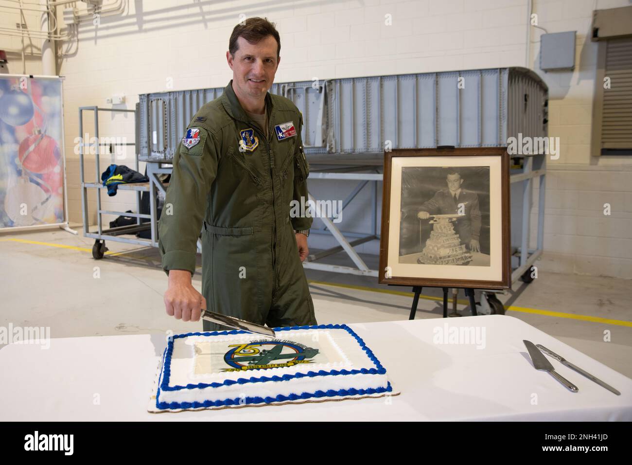 Col. Matthew Groves, 136th Airlift Wing commander, prepares to cut a ...