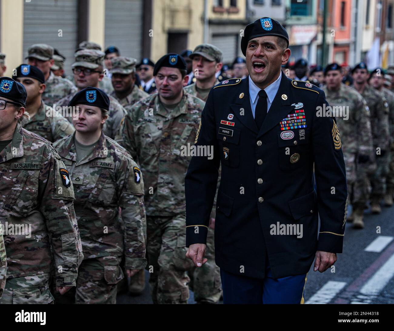 Soldiers in the 101st Airborne Division (Air Assault) march down the city of Bastogne, Belgium ...