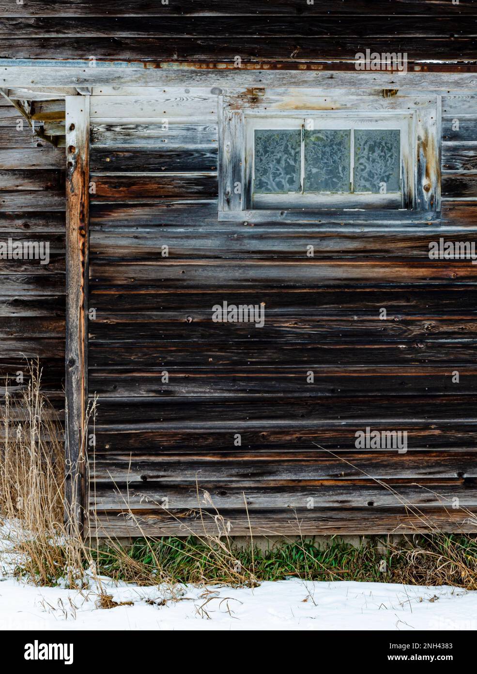 A window sits under a gutter on an abandoned farm out building, Door ...
