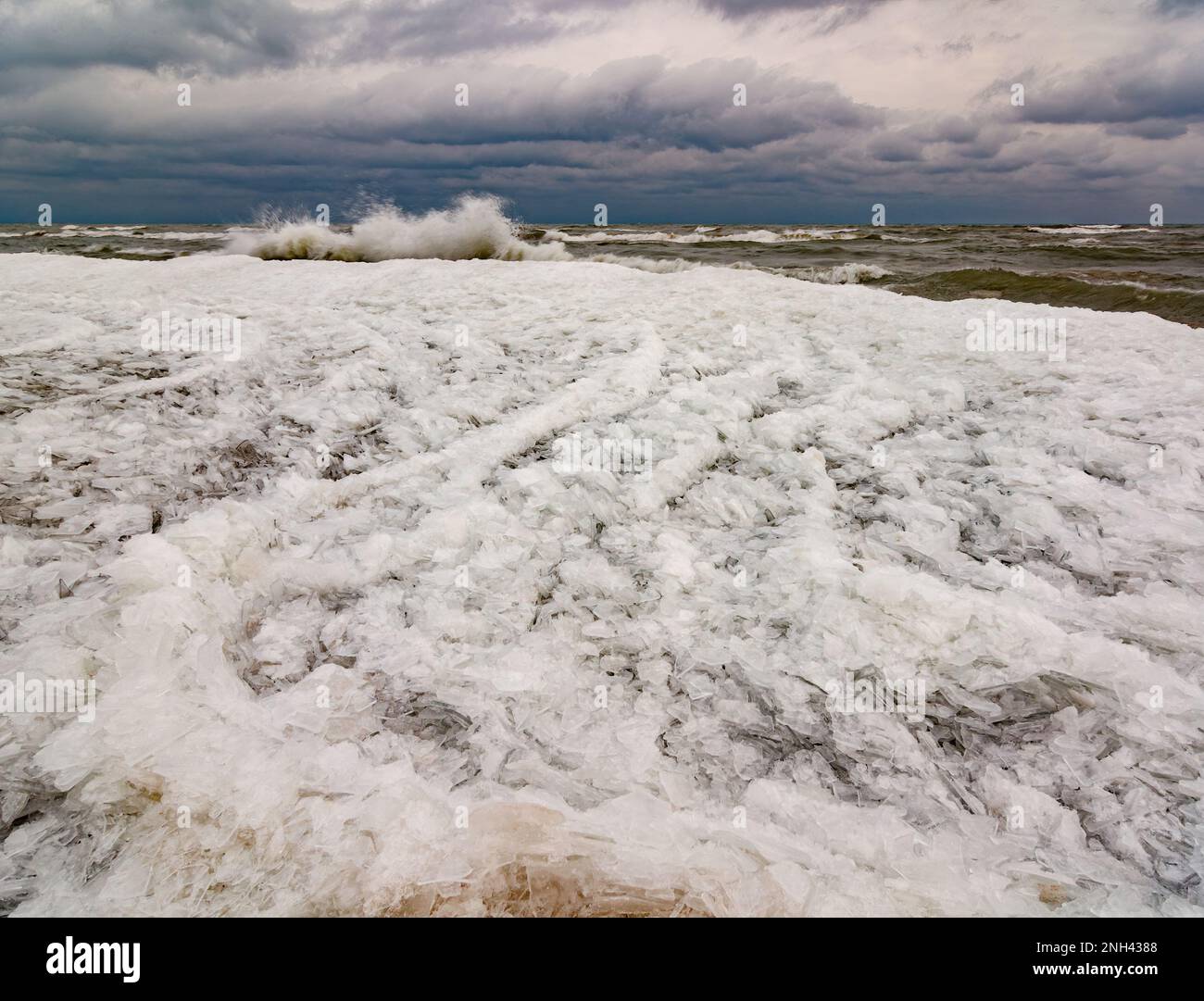 The Lake Michigan shoreline is covered with fractured ice that has ...