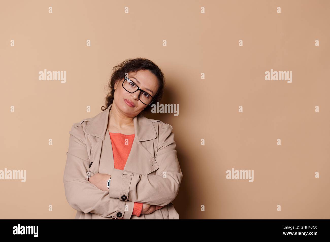Multi-ethnic mature woman wearing stylish spectacles, looking at camera ...