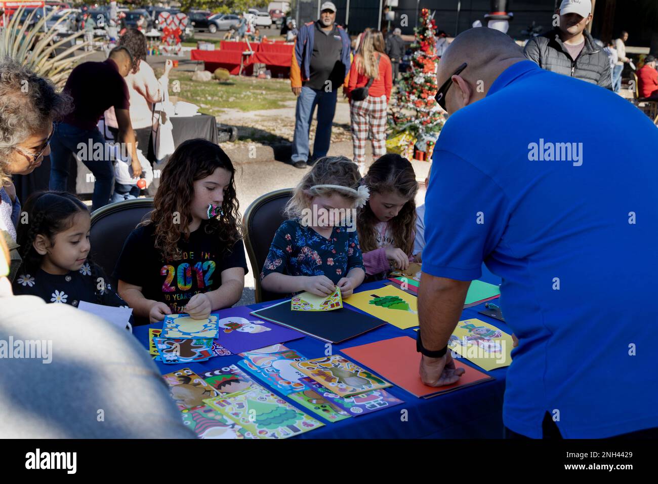 A volunteer with the Exceptional Family Member Program (EFMP) interacts with children at the ...