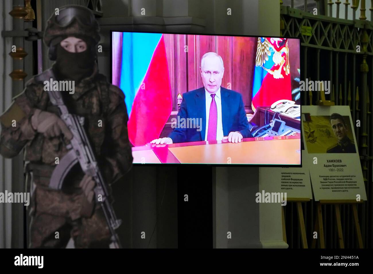 A TV screen shows Russian President Vladimir Putin announcing the ...