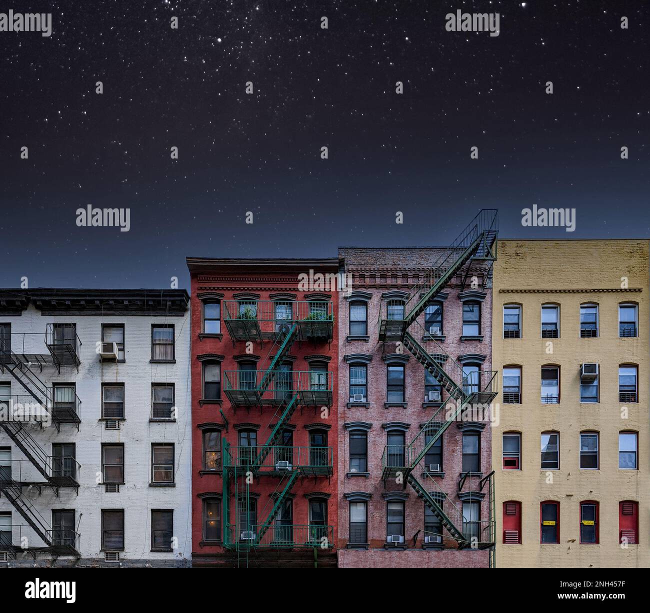 Old colorful New York City apartment buildings with star filled night ...