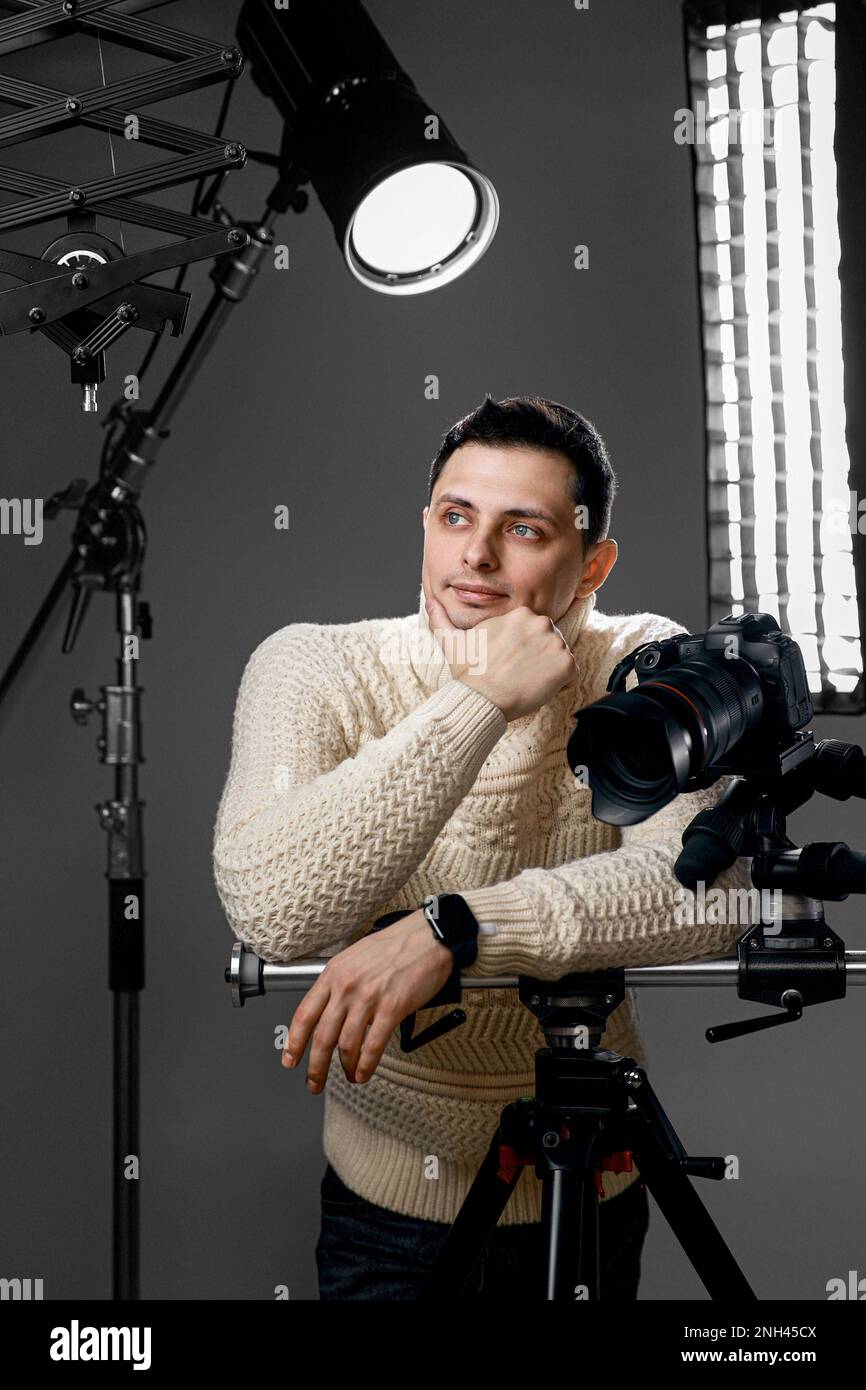 Professional handsome photographer with digital camera on tripod Stock ...
