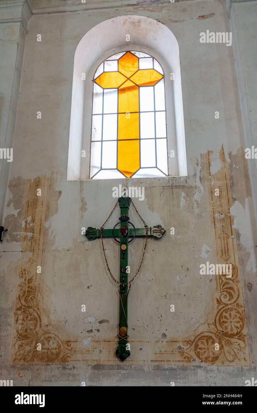 Antique wooden cross below a stained glass window, Church of Soledad ...