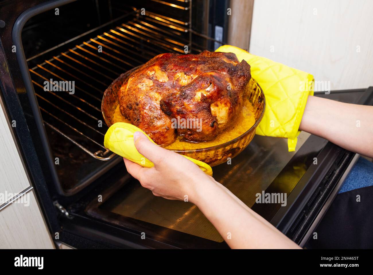 Woman taking roast dinner out of oven hi-res stock photography and ...
