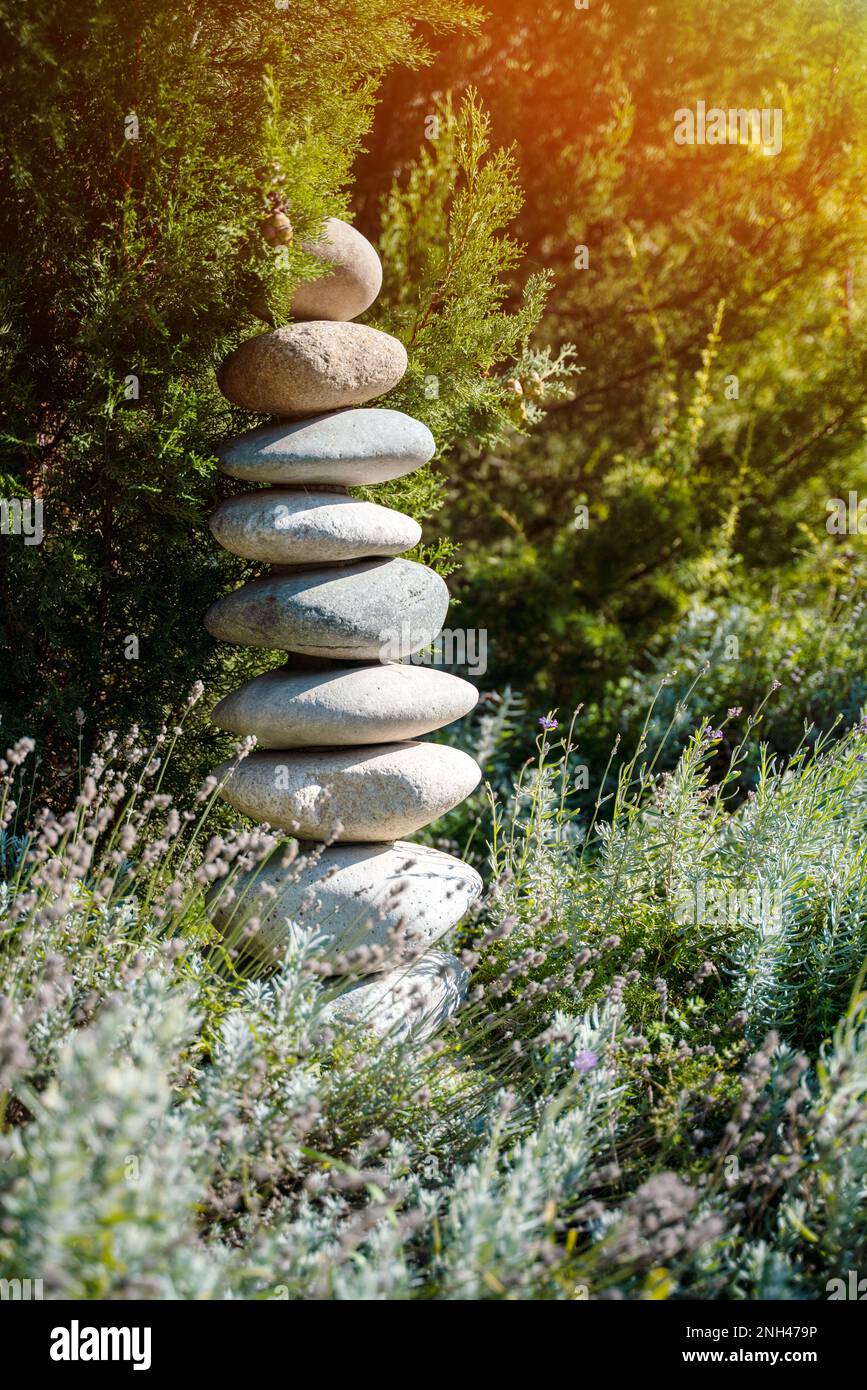 Balance stones are arranged in a pyramid shape,Stone Stacked on green ...