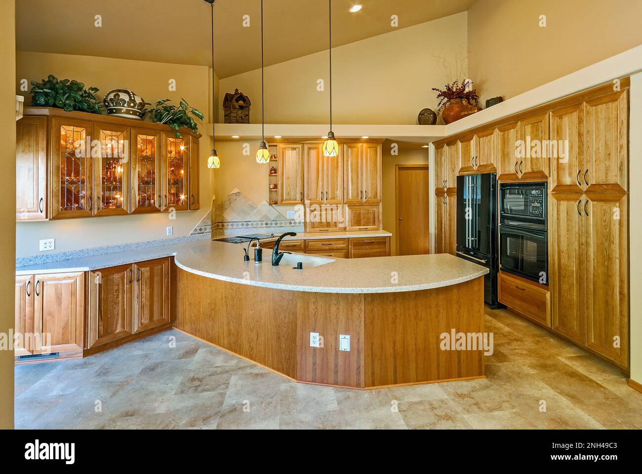 Views of a semi-circular countertop and wood cabinets in this ...
