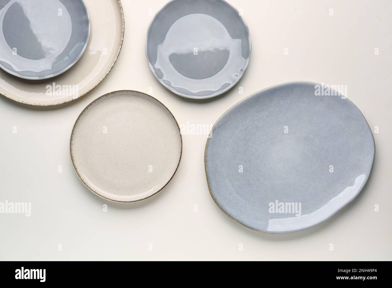 Set of plates on white background Stock Photo - Alamy