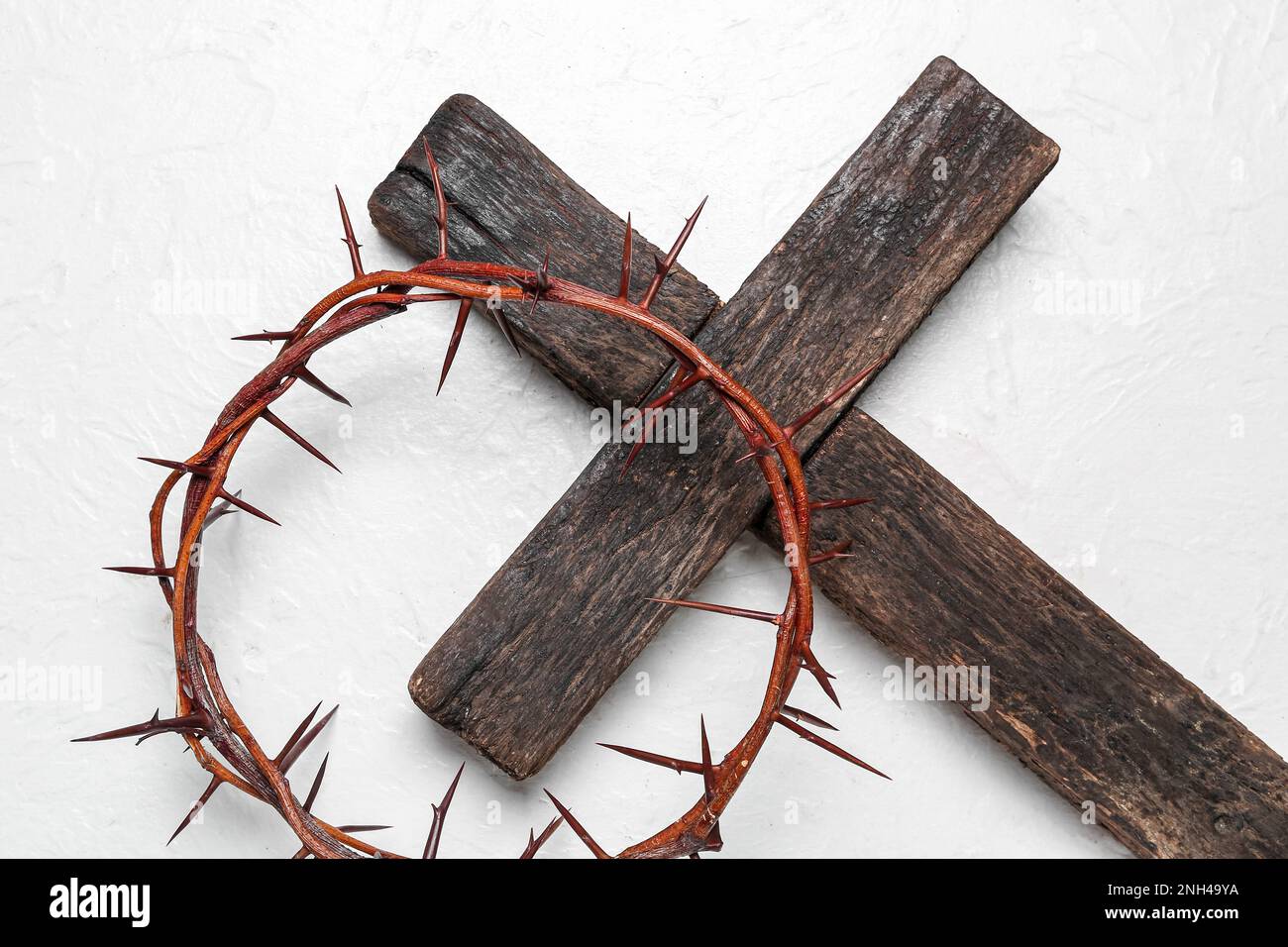 Crown of thorns with wooden cross on white background. Good Friday ...