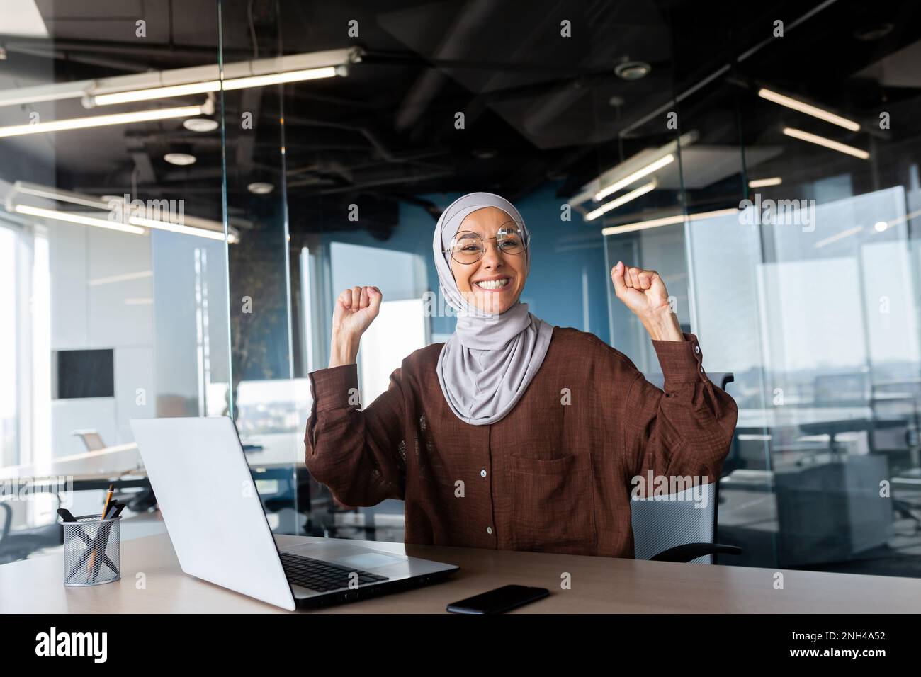 Portrait of happy smiling and successful muslim at work in office ...