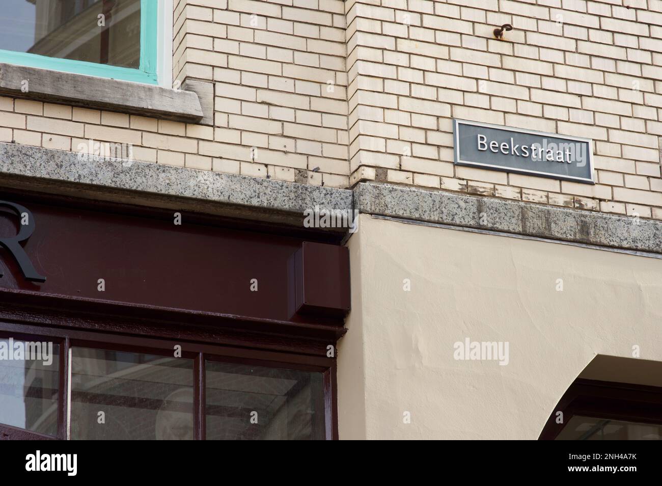 Blue street name sign of Beekstraat on a brick stone wall in Arnhem in ...