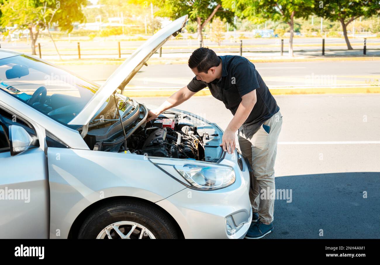 Driver checking the oil in his vehicle. Person checking the oil level ...