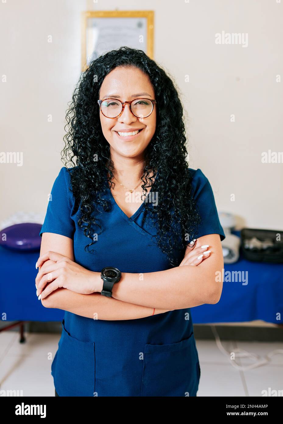 Portrait of smiling woman physiotherapist. Crossed arms african ...