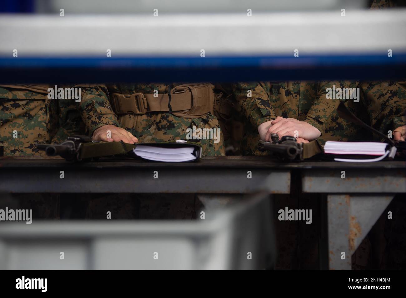 Two M16A4 service rifles rest on a table during a rifle issue for Hotel ...