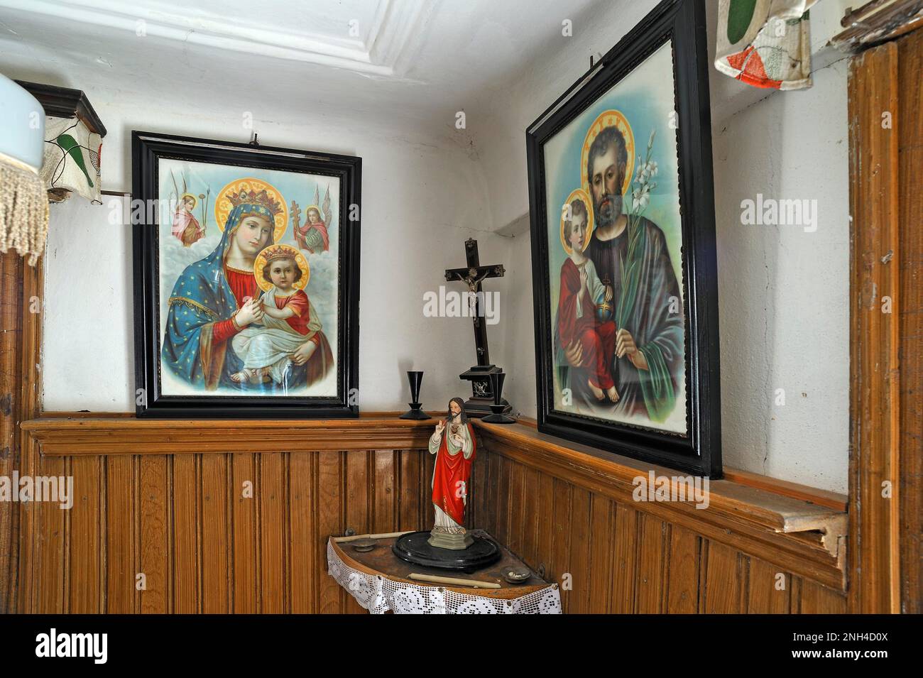 Corner with pictures of saints and a Christ figure in a parlour at the ...