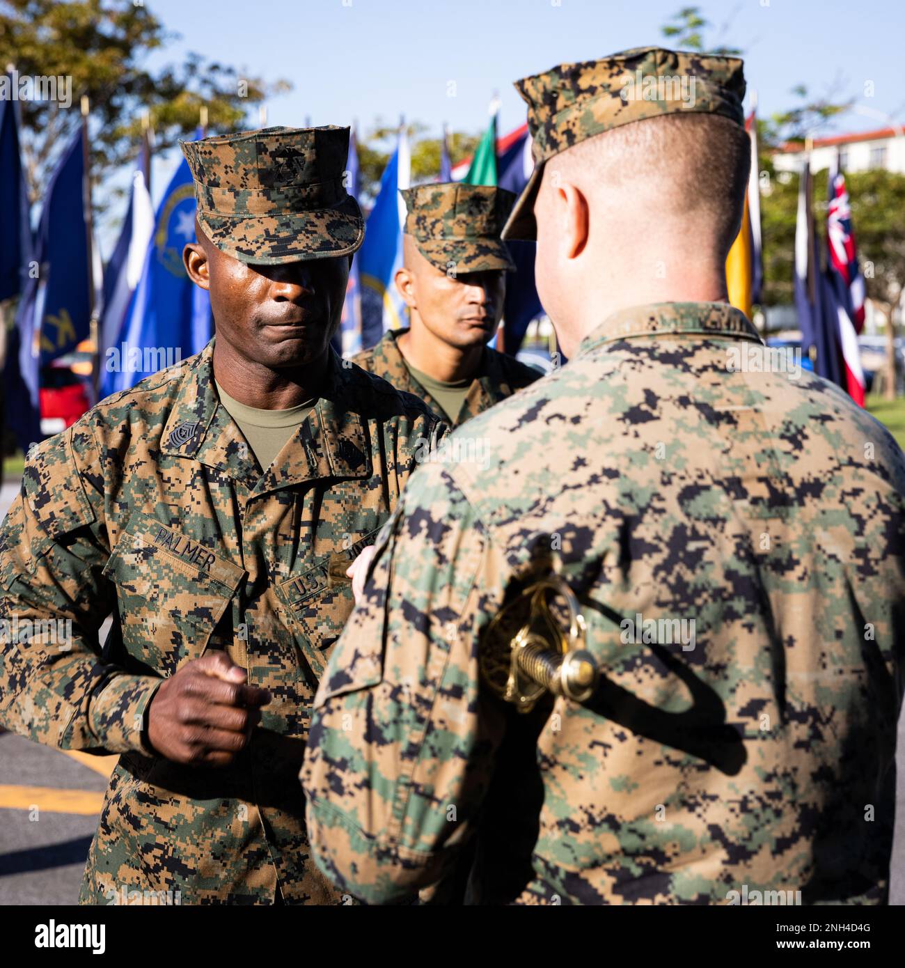 U.S. Marine Corps Sgt. Maj. Rupert K. Palmer(left) passes a noncommissioned officer sword to Lt ...