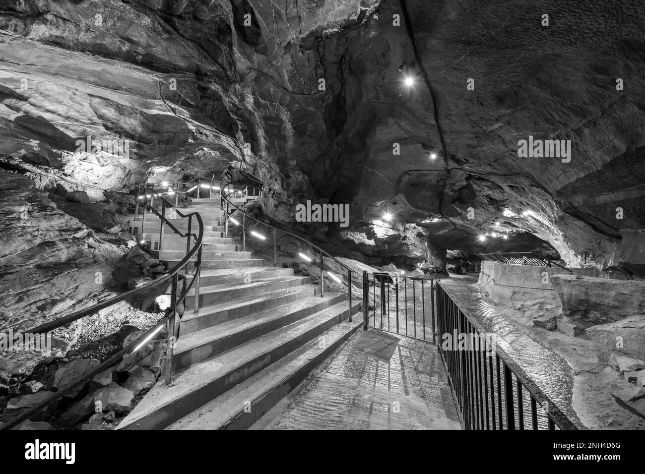 An illuminated staircase inside Goughs Cave in Cheddar in Somerset ...