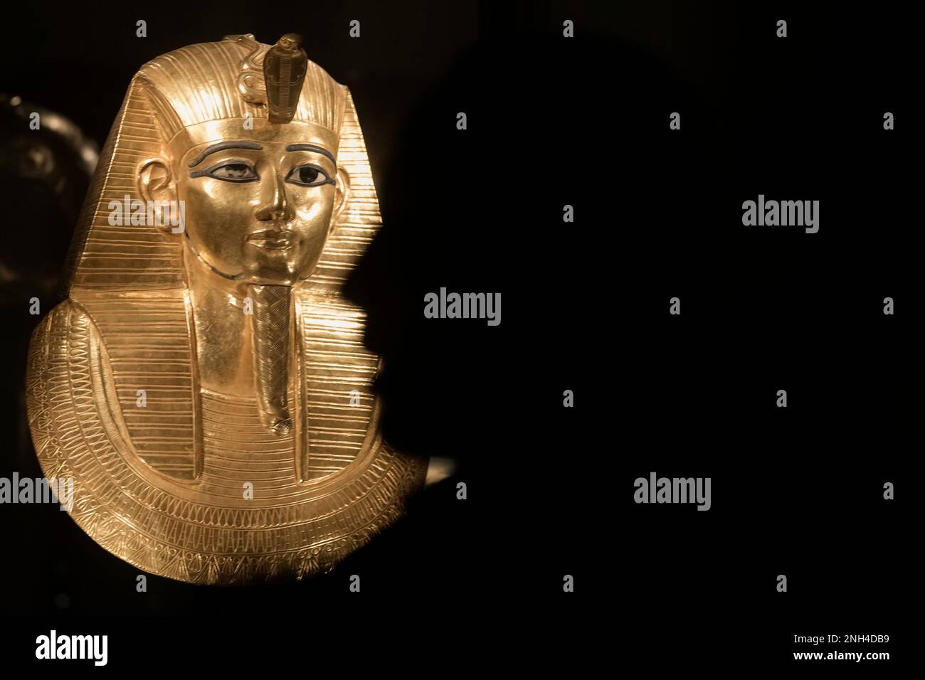A visitor watches a recently displayed golden funerary mask of king ...