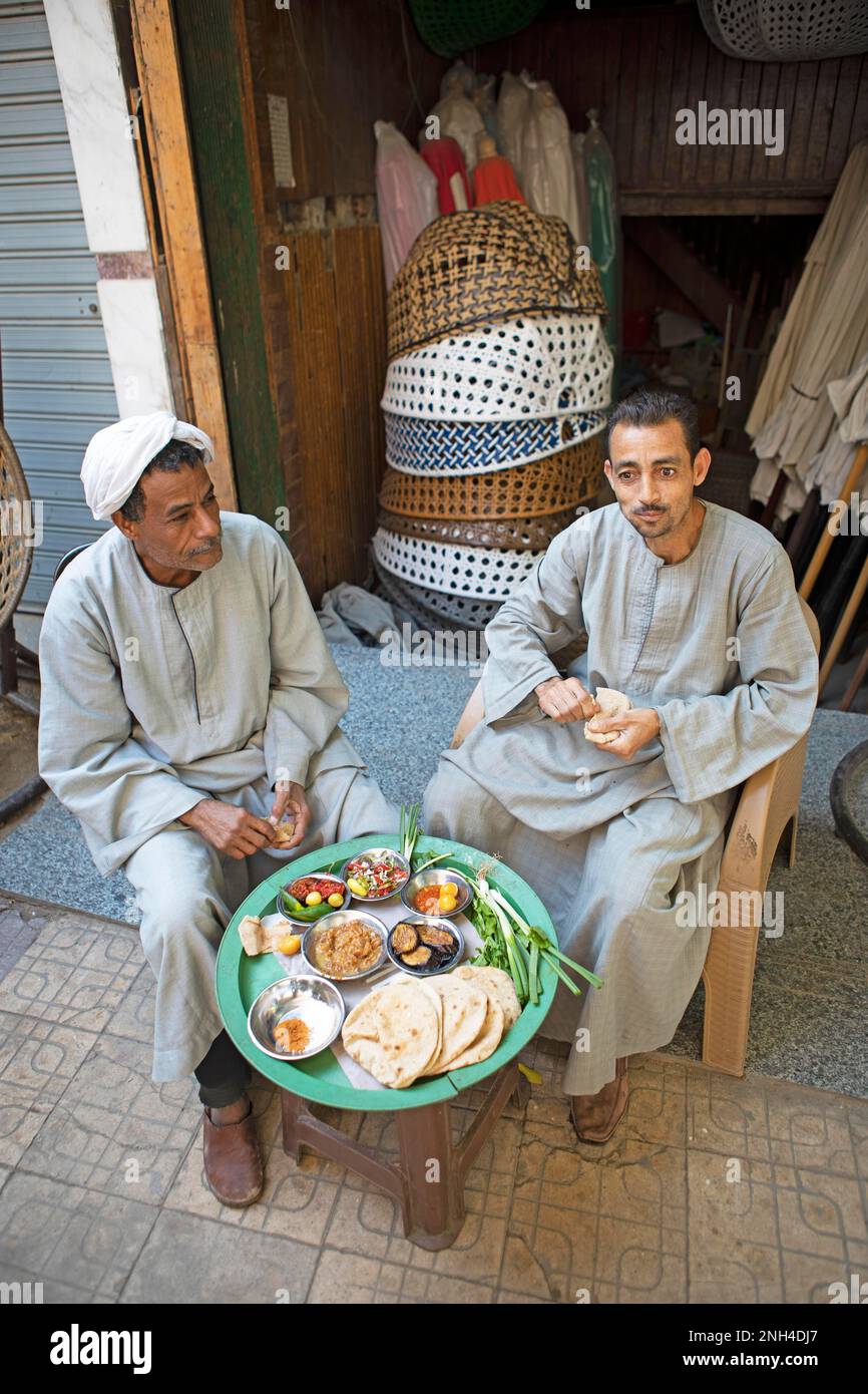 Egyptian men in traditional dress eating traditional food, Old City ...