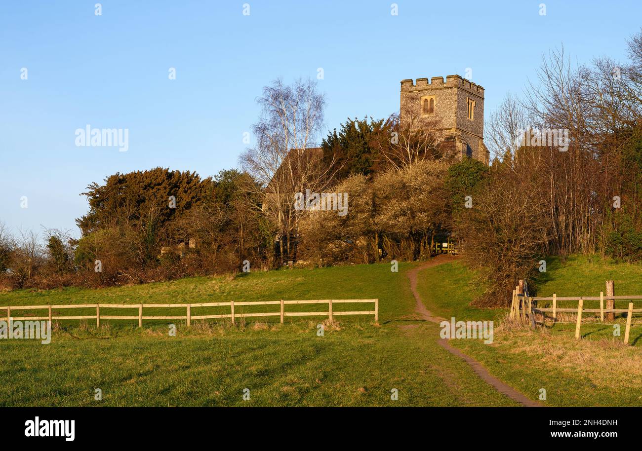 Church in the English countryside with field and trees. Late afternoon ...